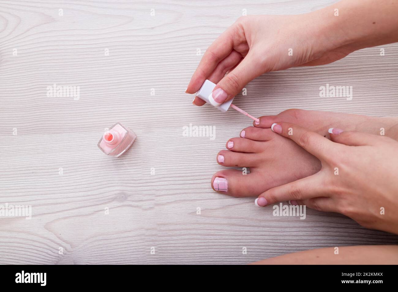 Woman applying pink nail polish hi-res stock photography and images - Alamy