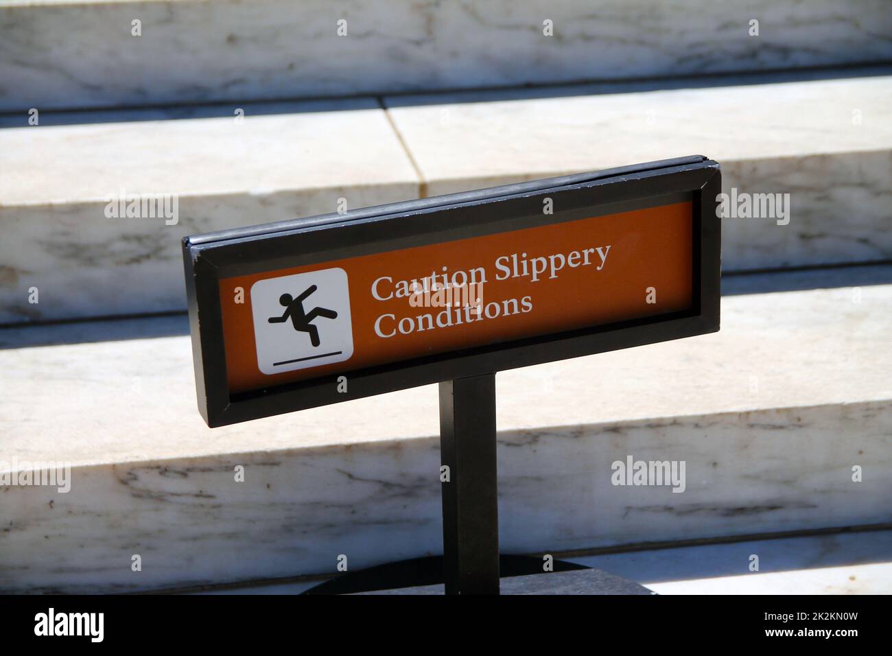 Caution, slippery conditions brown sign with icon representation on ...