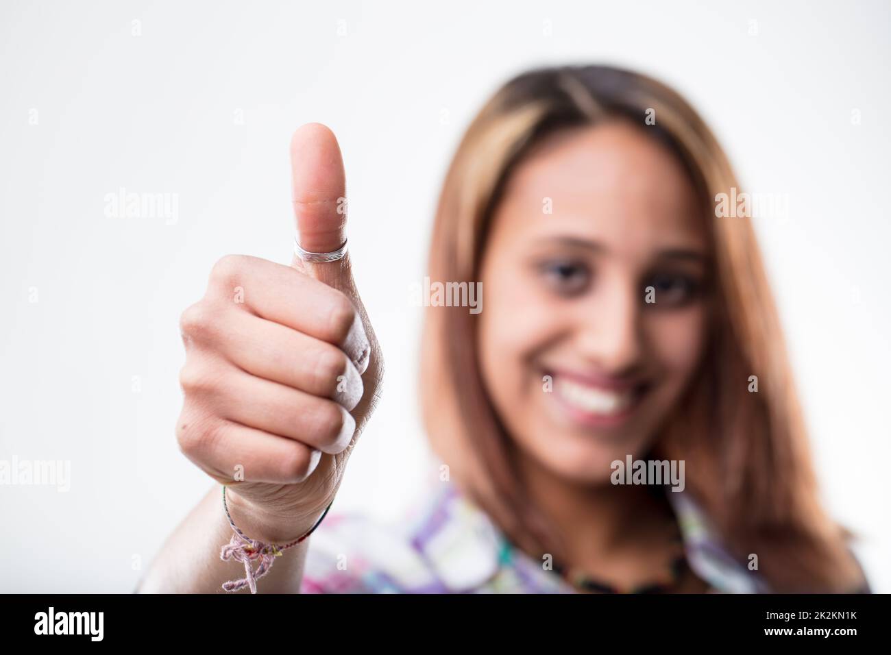 Smiling happy woman giving a thumbs up Stock Photo - Alamy