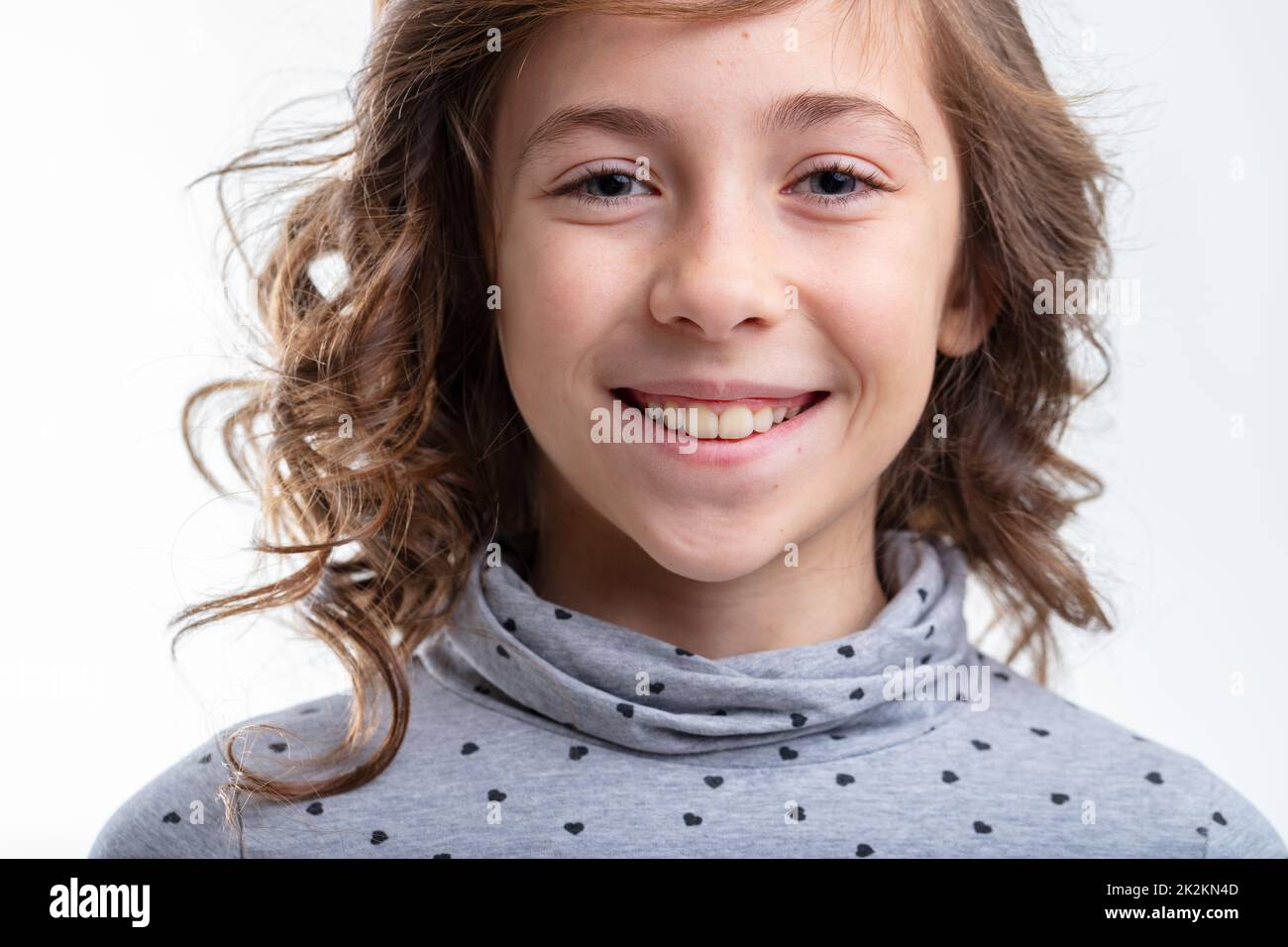 Cute little girl with a charismatic grin isolated on white Stock Photo ...