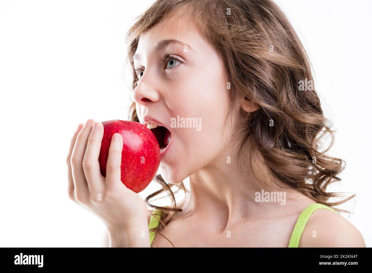 girl eats red apple on white background Stock Photo - Alamy