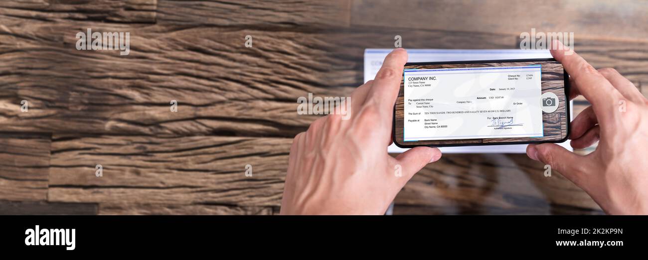 Man Taking Photo Of Cheque To Make Remote Deposit Stock Photo - Alamy