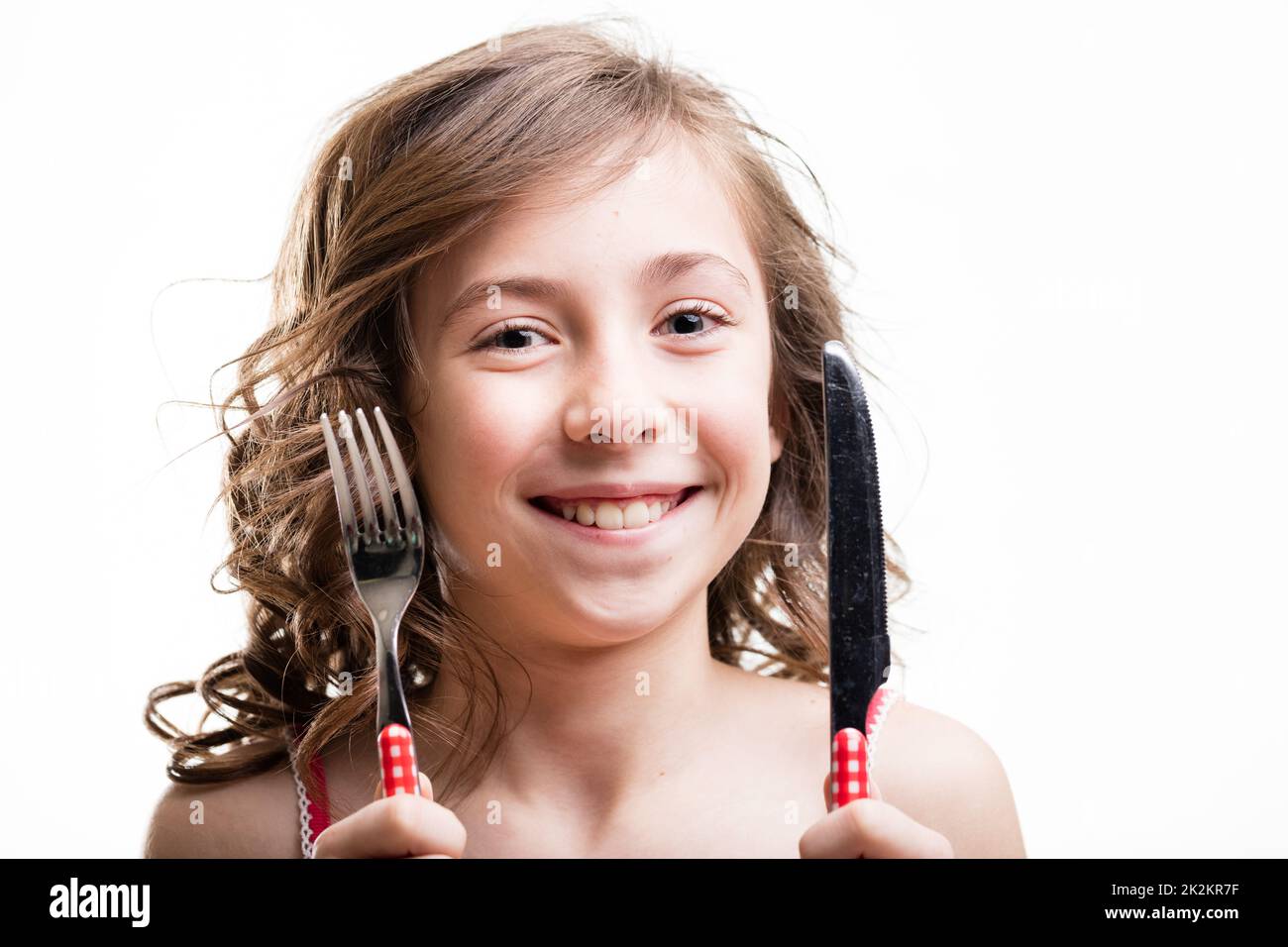 smiling girl with fork and knife Stock Photo - Alamy