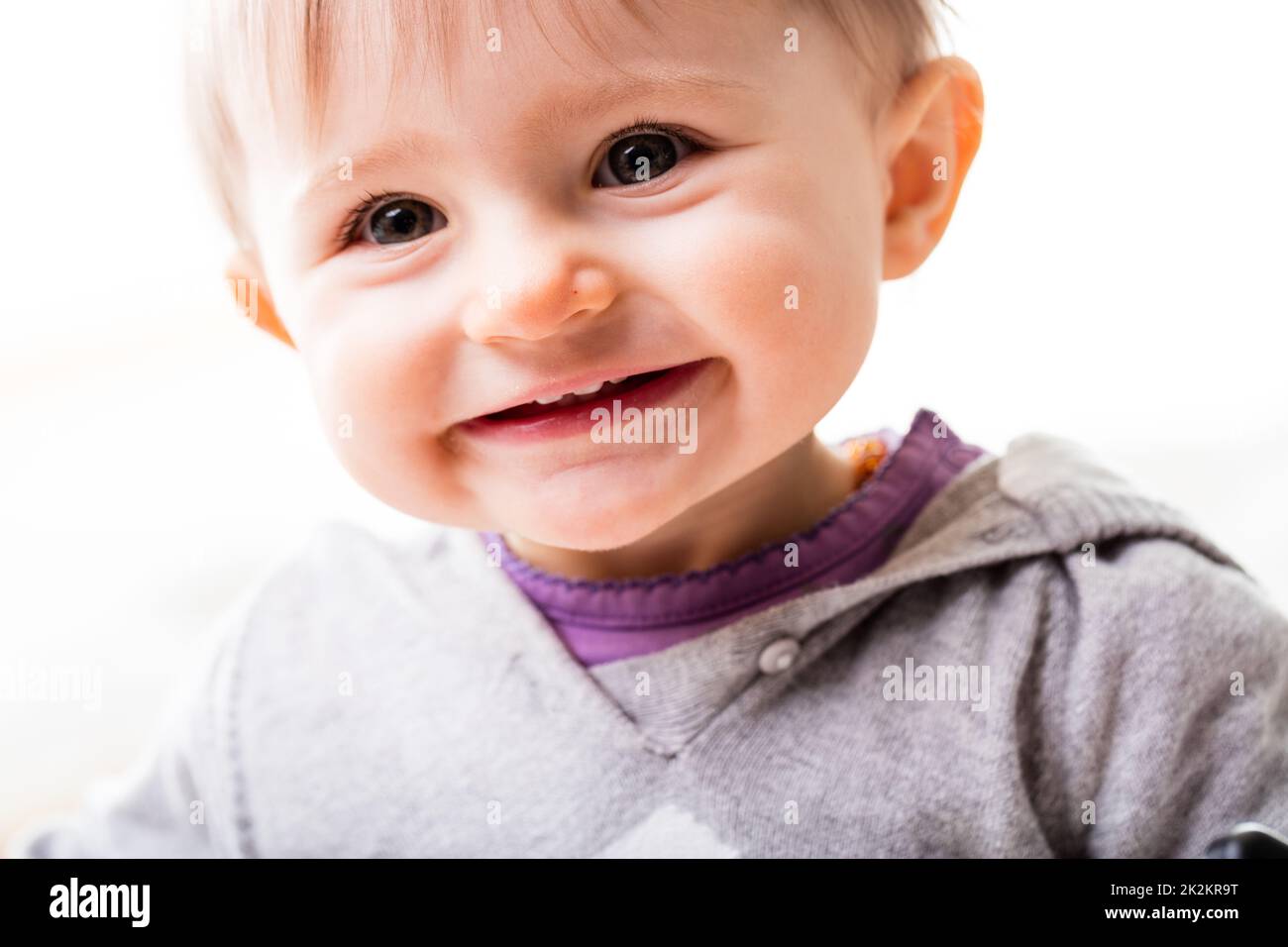 little children looking at something and smiling Stock Photo - Alamy