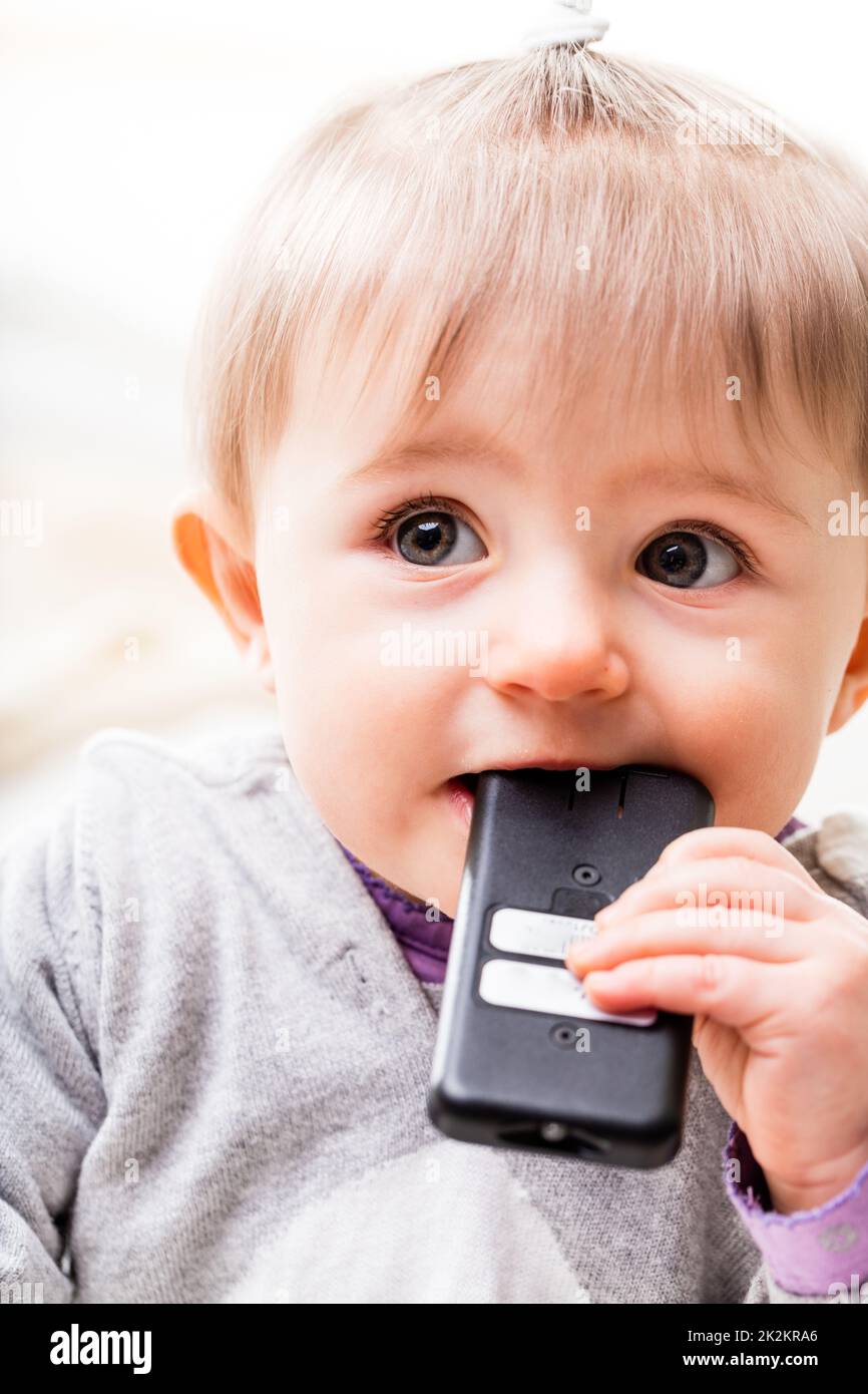 child tasting a remote control to check Stock Photo - Alamy