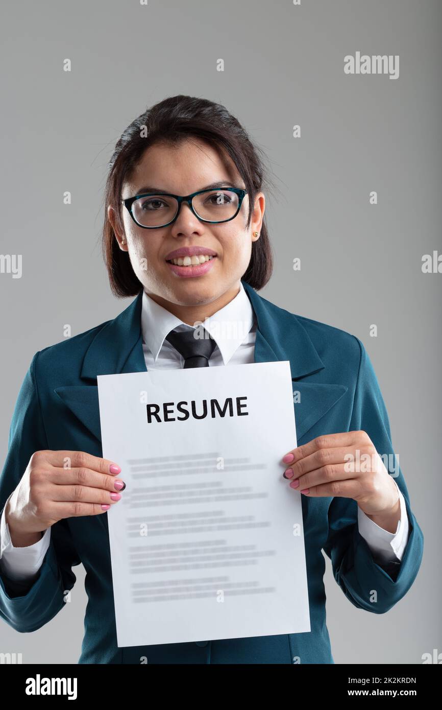 Smart young businesswoman holding up a Resume Stock Photo - Alamy