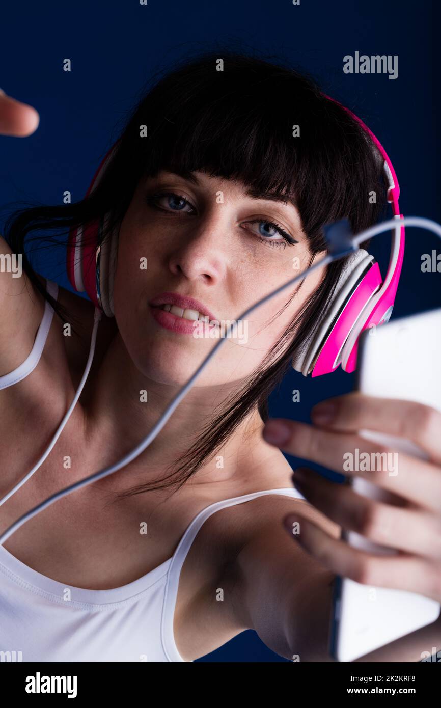 Beautiful woman reaching arms outward over blue Stock Photo - Alamy