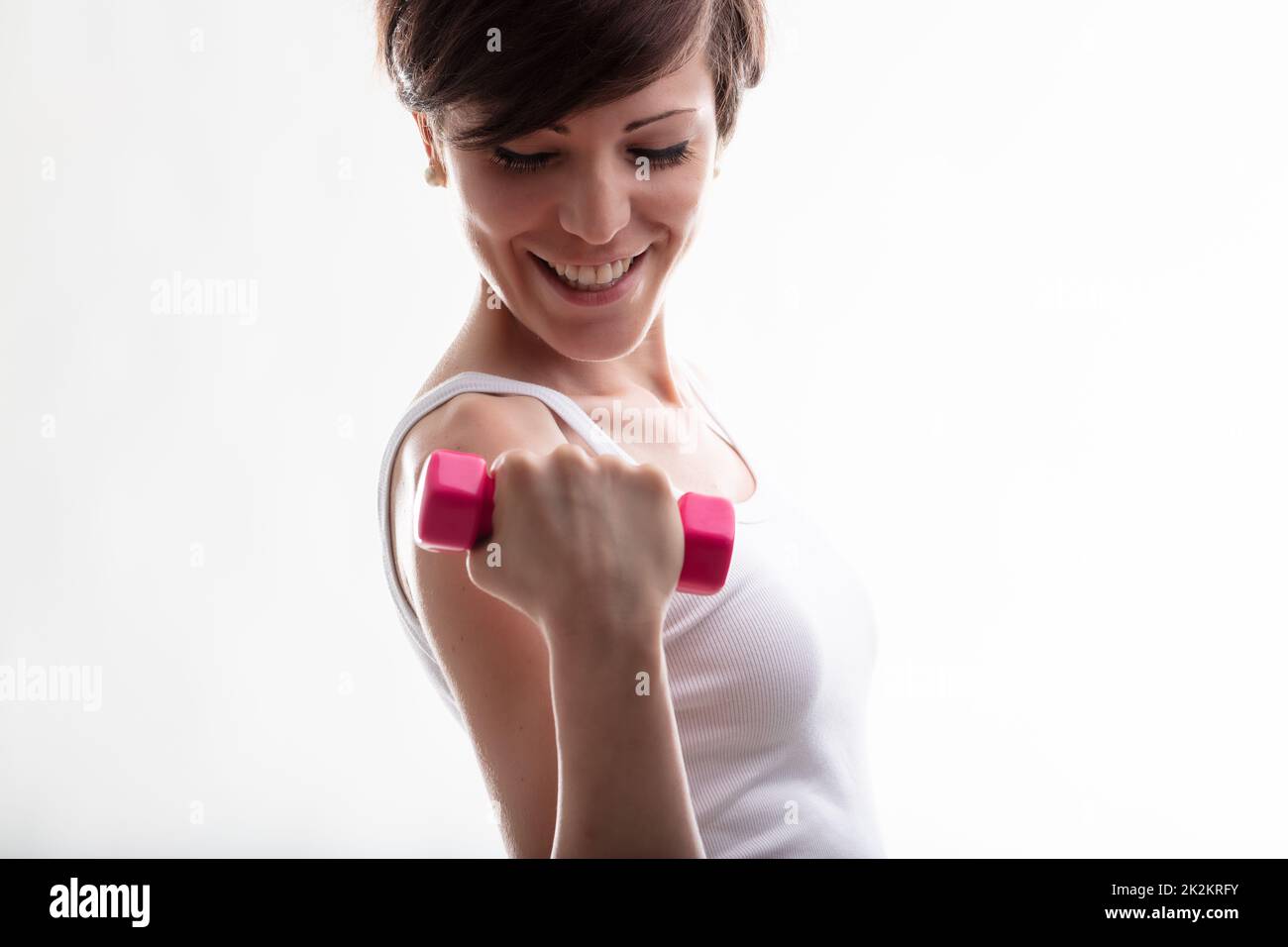 Happy healthy young woman working out lifting weights Stock Photo - Alamy
