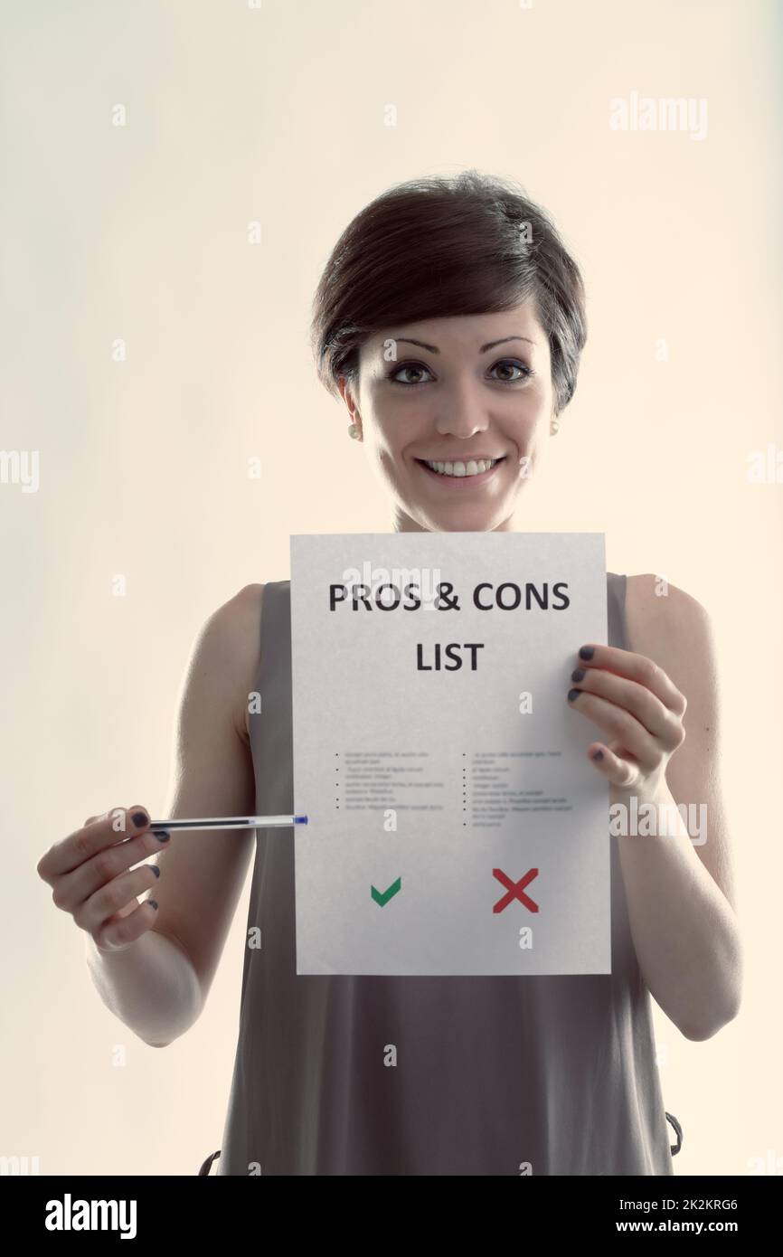 Portrait of a woman showing an organized list of pros and cons Stock ...