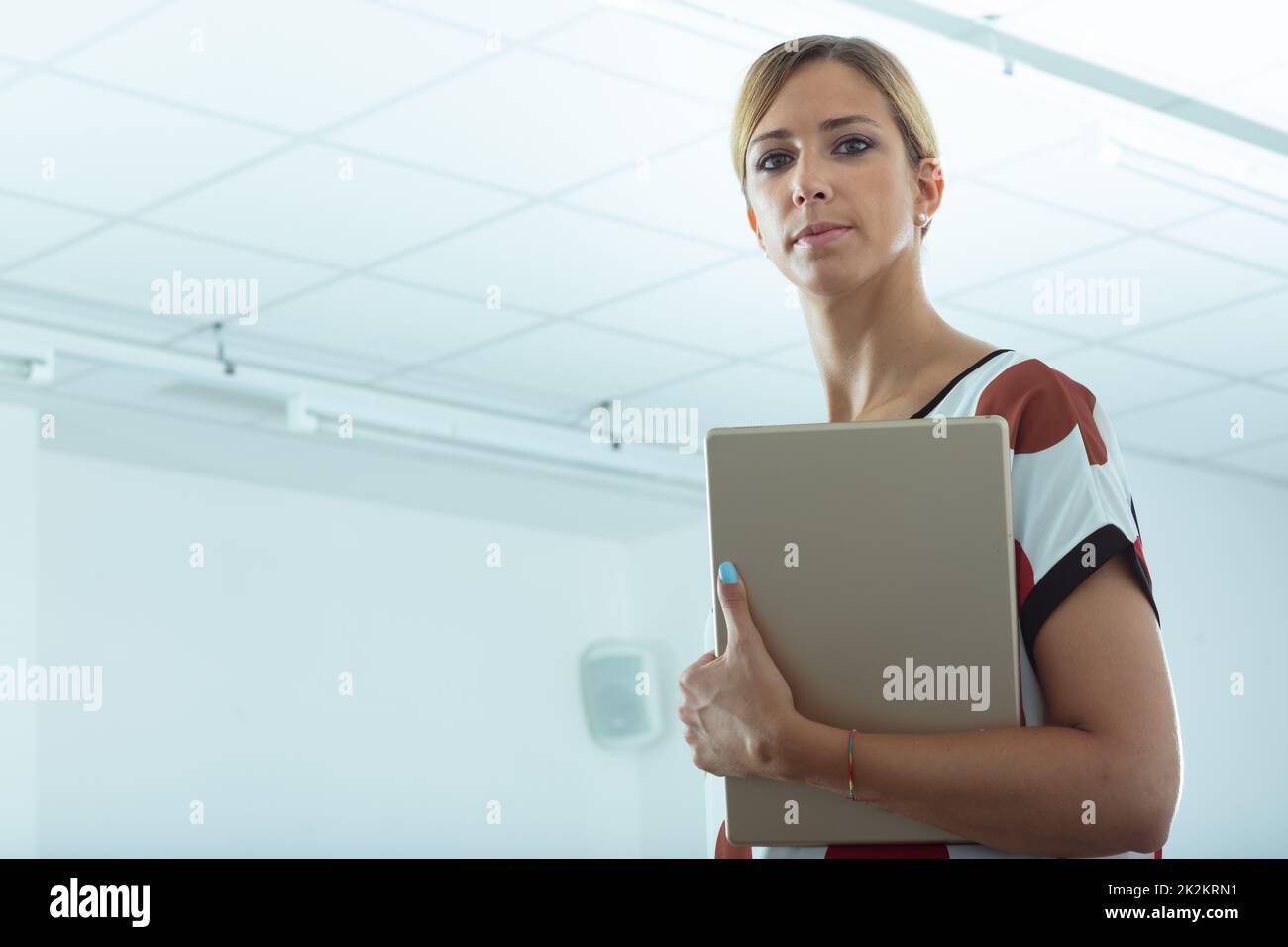 Thoughtful astute businesswoman standing staring at the camera Stock ...