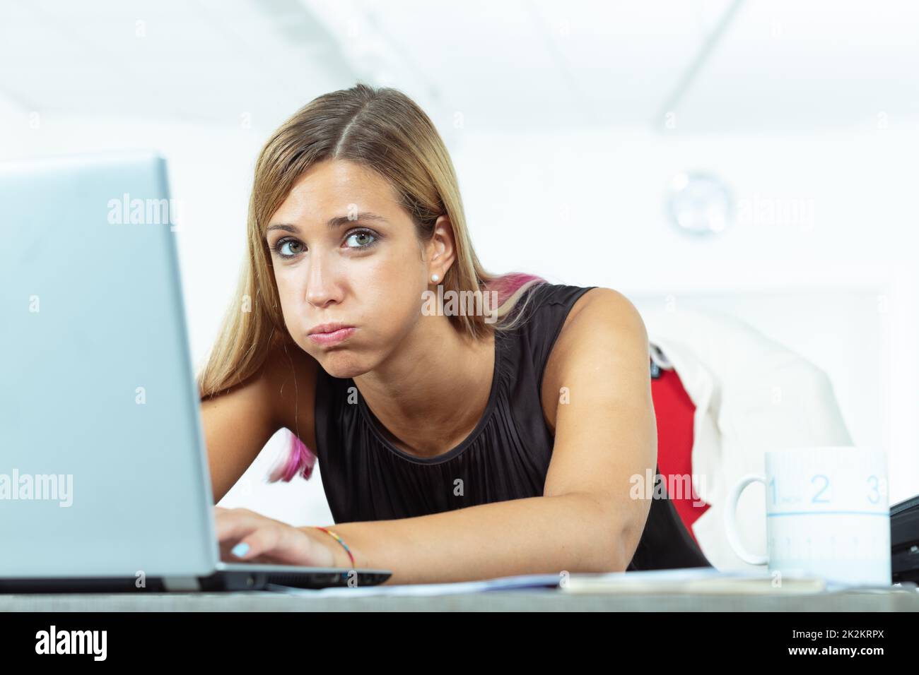 Stressed overworked businesswoman blowing out her cheeks Stock Photo ...