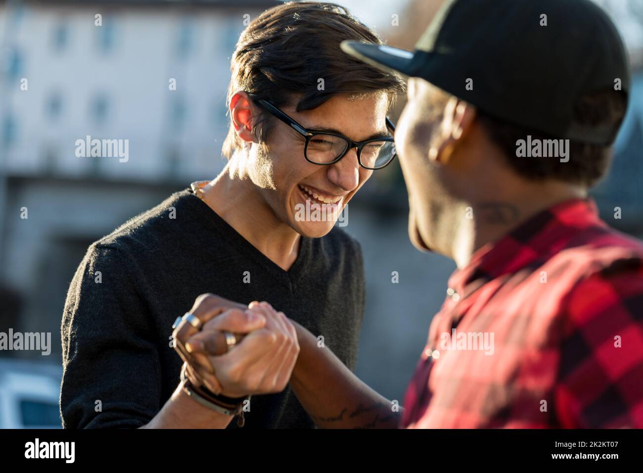good friends joking about their secret handshake Stock Photo - Alamy