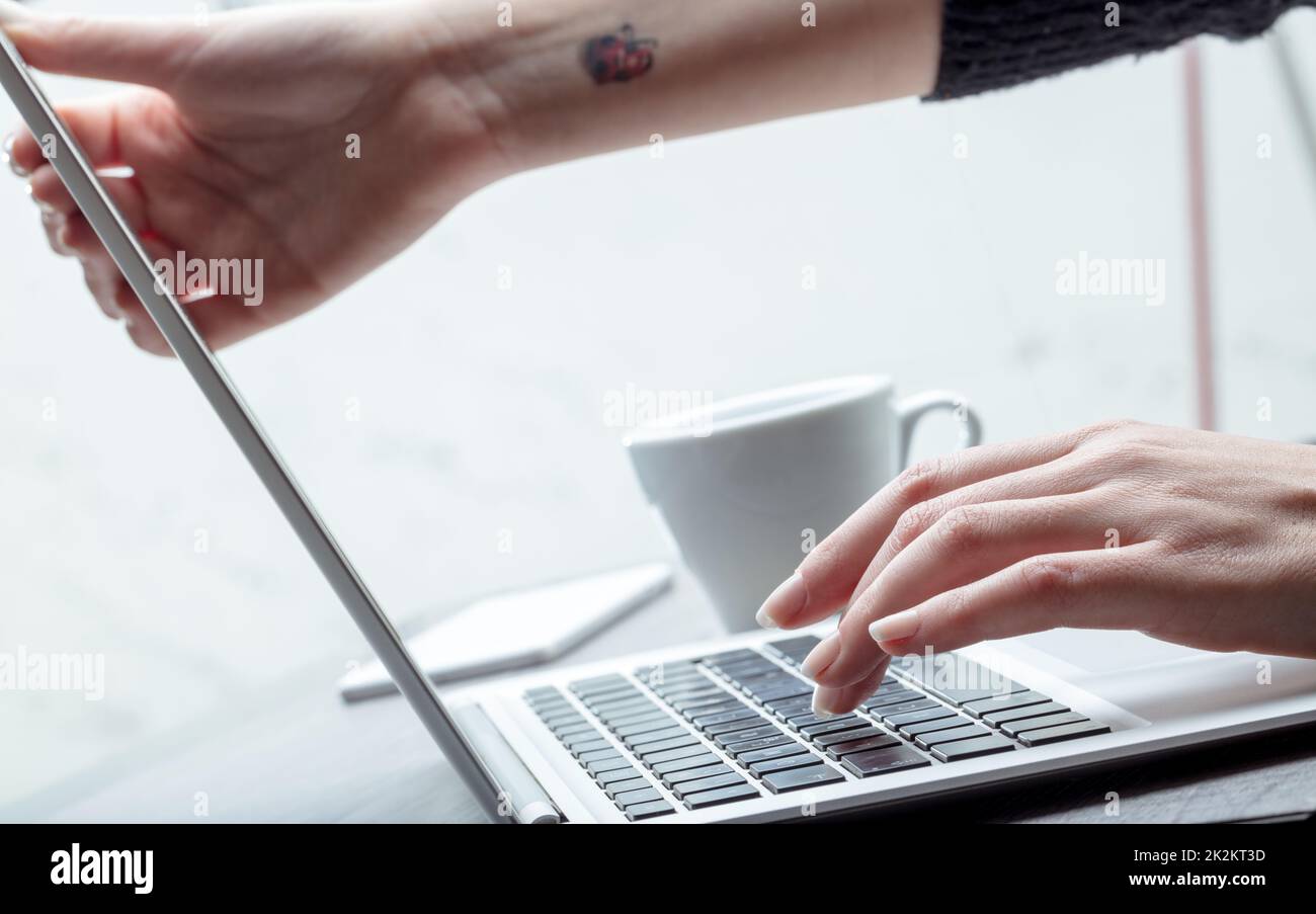 Businesswoman adjusting her screen height Stock Photo - Alamy