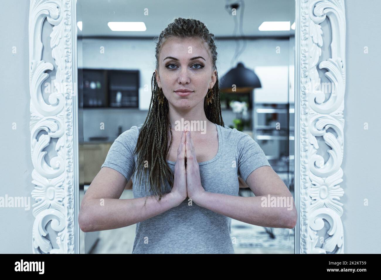 yoga namaste salutation by young woman with dreadlocks Stock Photo - Alamy