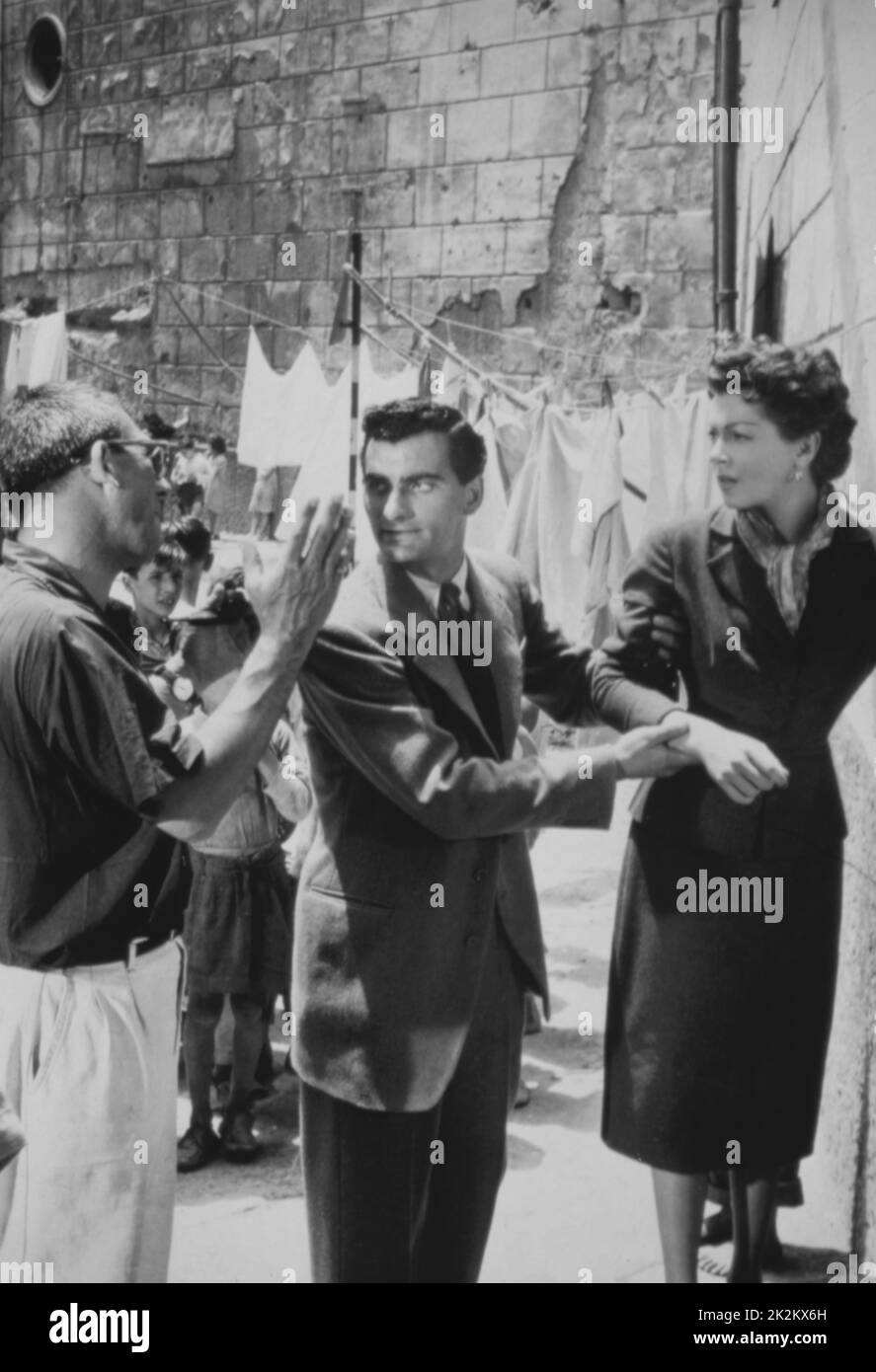 Richard Brooks with Bonar Colleano and Lana Turner on the set of: Flame ...