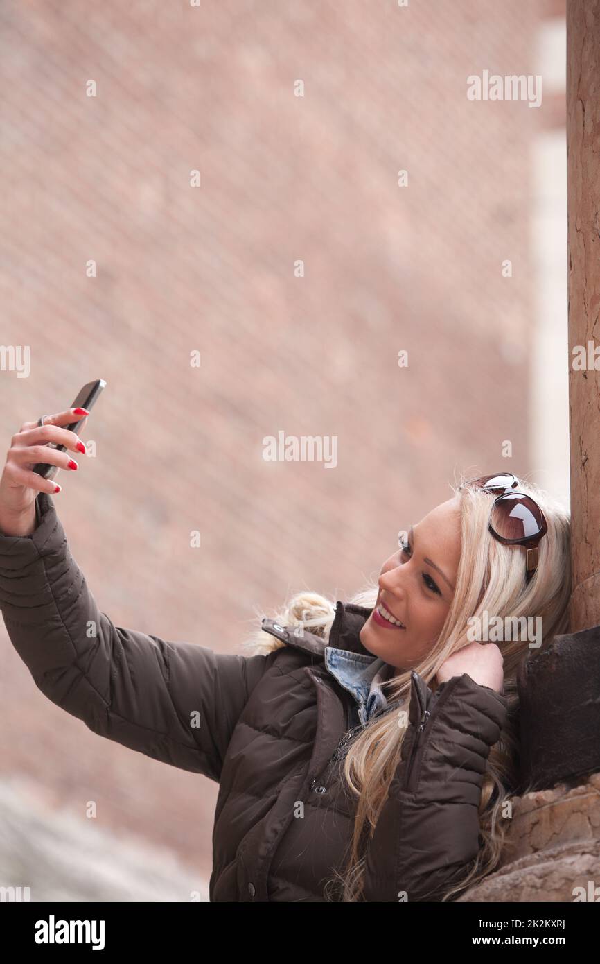 Smiling blonde taking selfie smartphone hi-res stock photography and ...