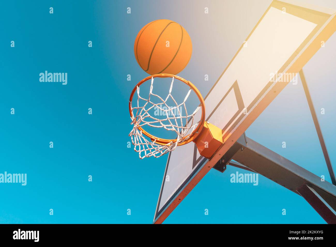 Street basketball ball falling into the hoop Stock Photo - Alamy