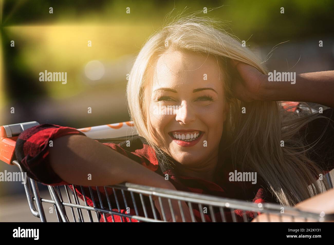 Laughing playful woman posing in a shopping cart Stock Photo - Alamy
