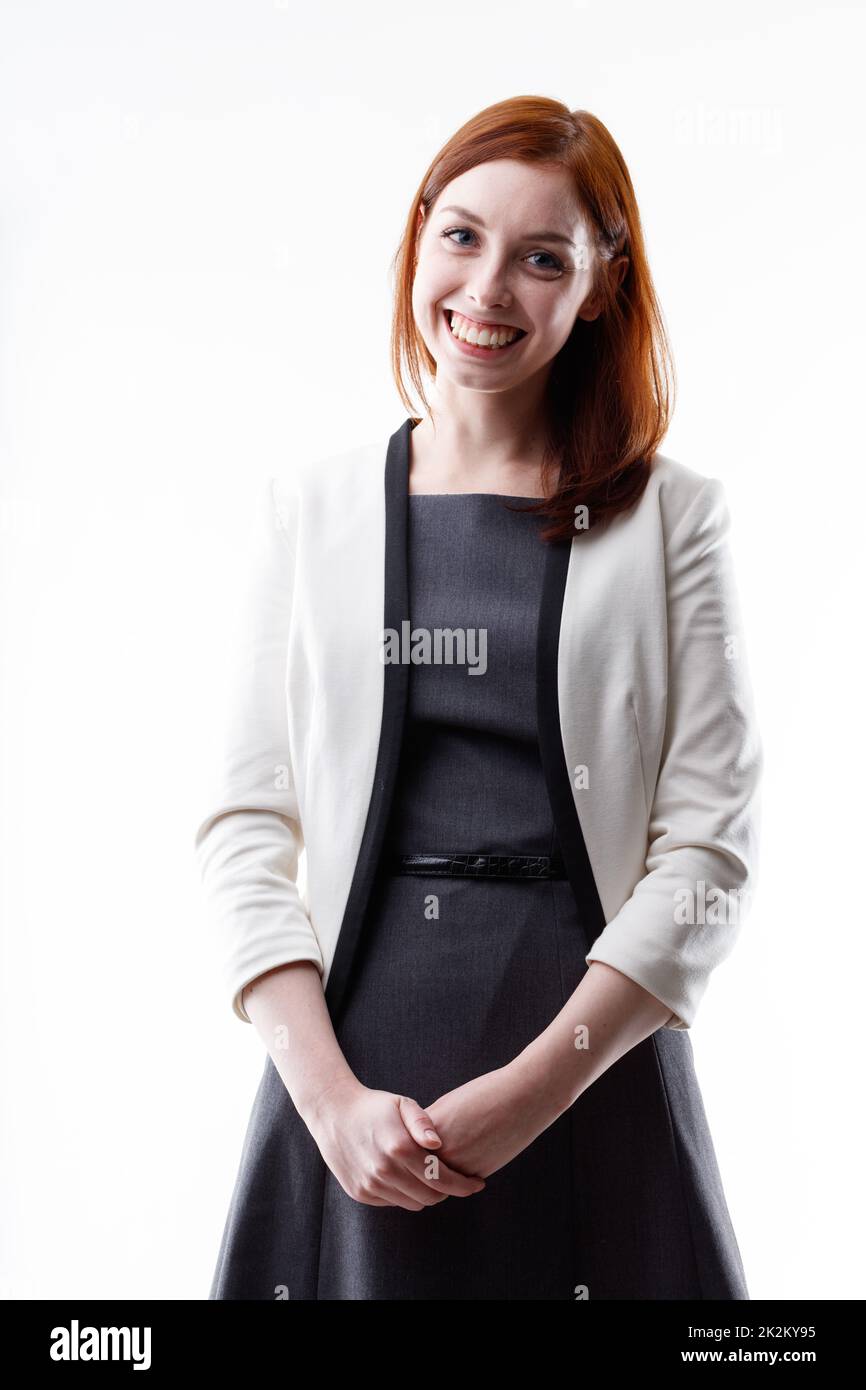 Young woman giving the camera am happy toothy grin Stock Photo - Alamy