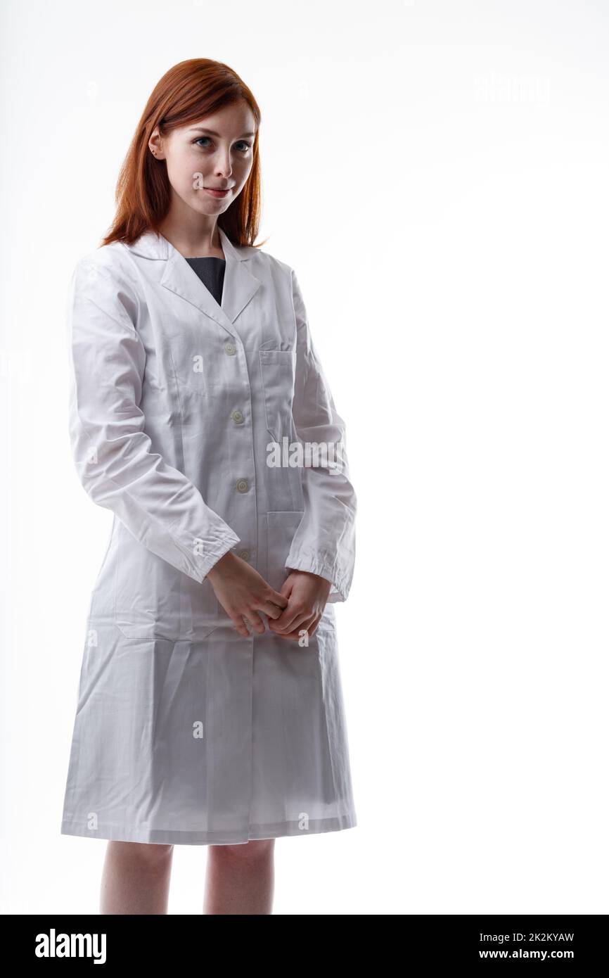 Smiling friendly woman in a plain white lab coat Stock Photo - Alamy