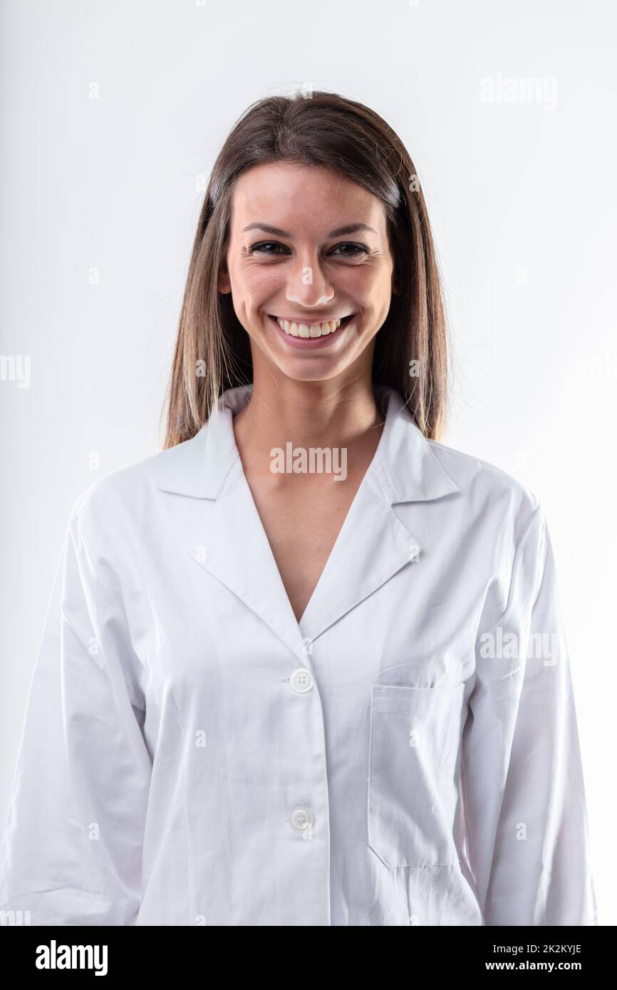 Welcoming motivated young woman in a white lab coat Stock Photo - Alamy