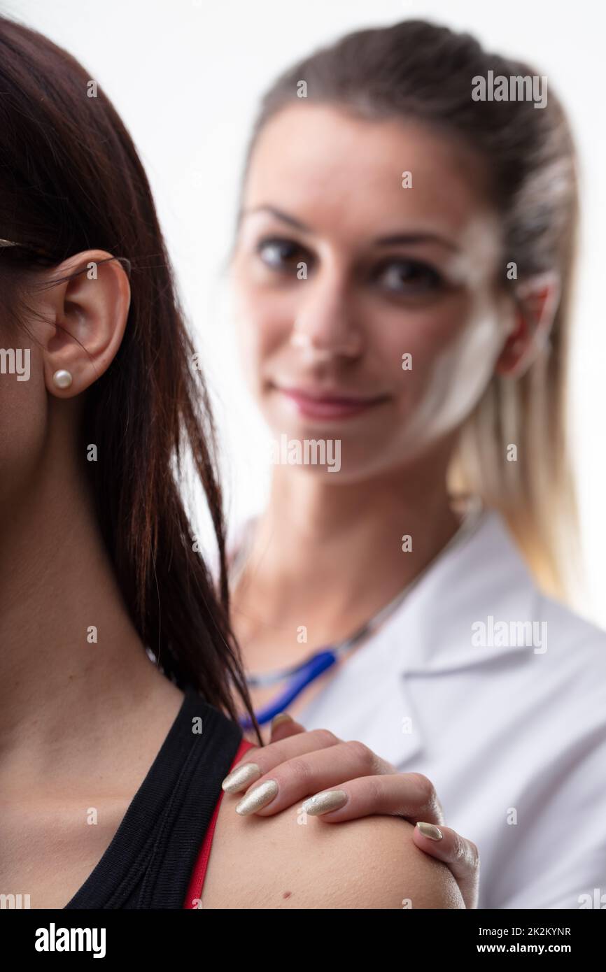 Doctor looking over a patients shoulder with a smile Stock Photo - Alamy