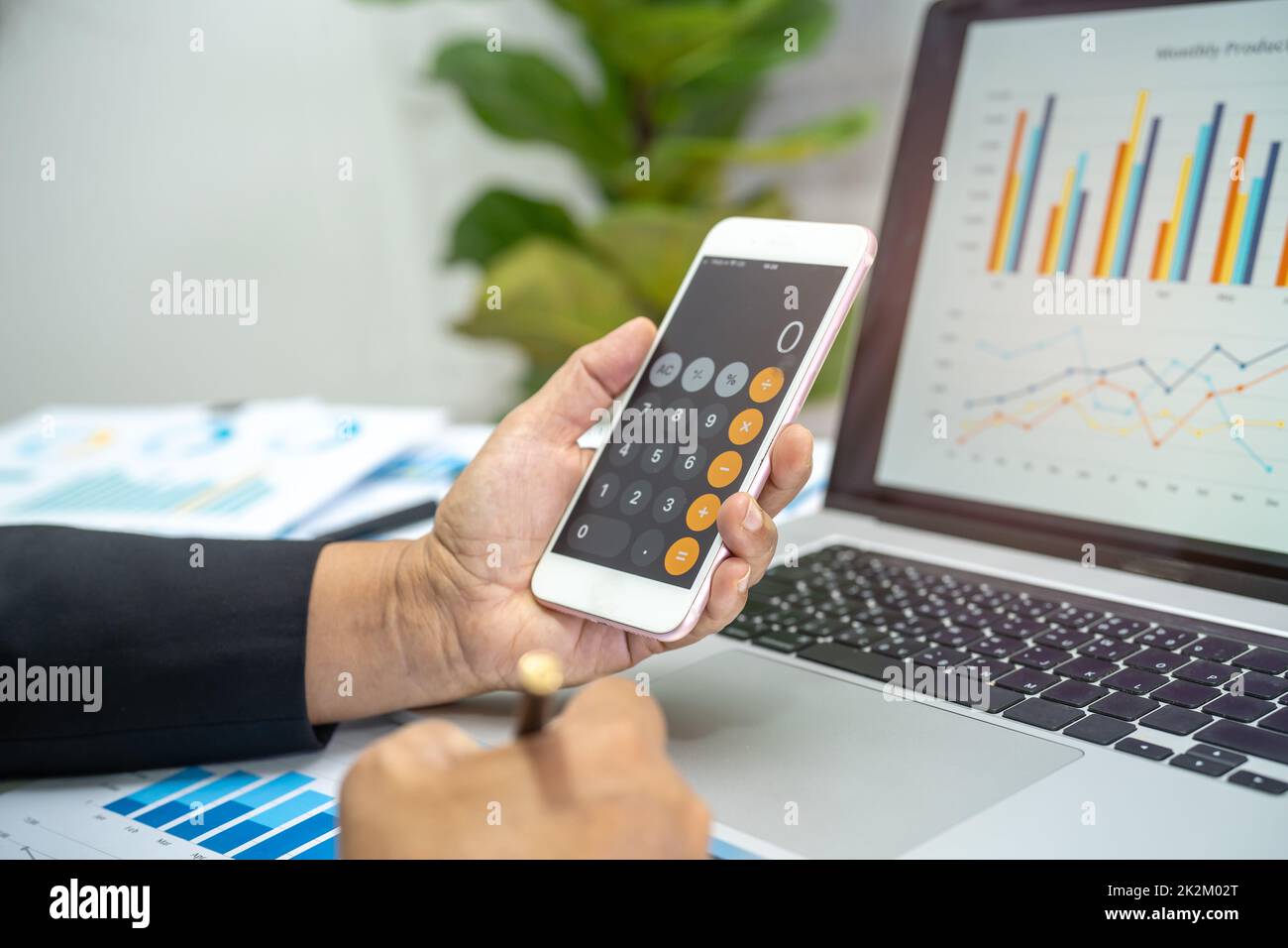 Asian accountant working and analyzing financial reports project ...