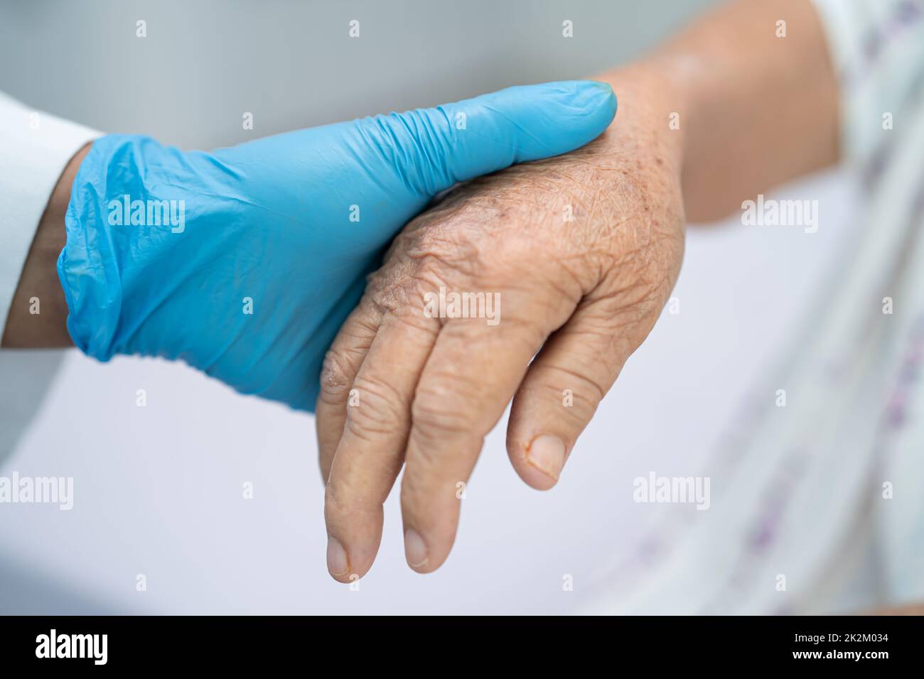 Doctor holding touching hands Asian senior or elderly old lady woman ...