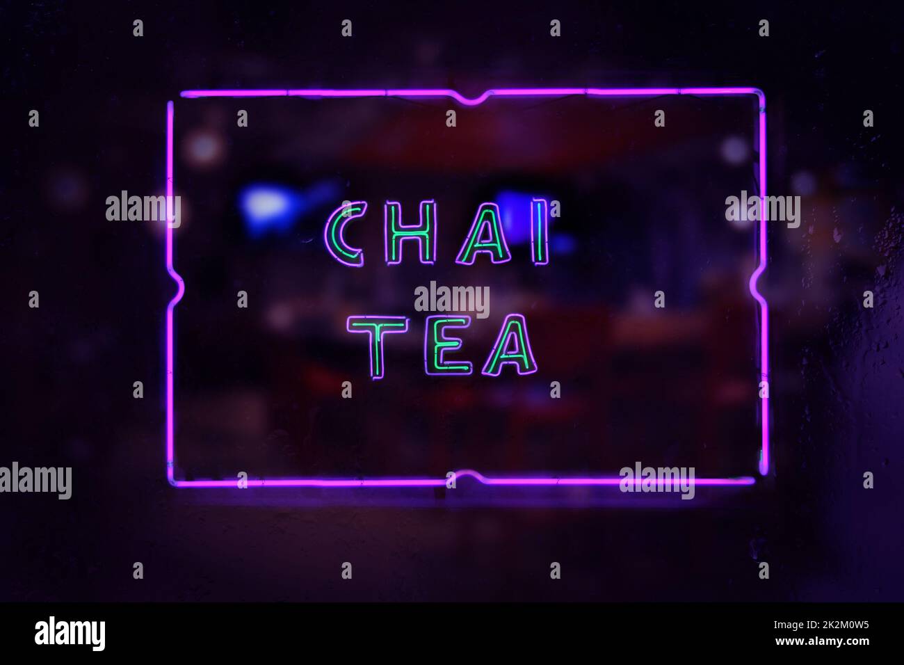 Neon Chai Tea Sign in Rainy Window Stock Photo - Alamy