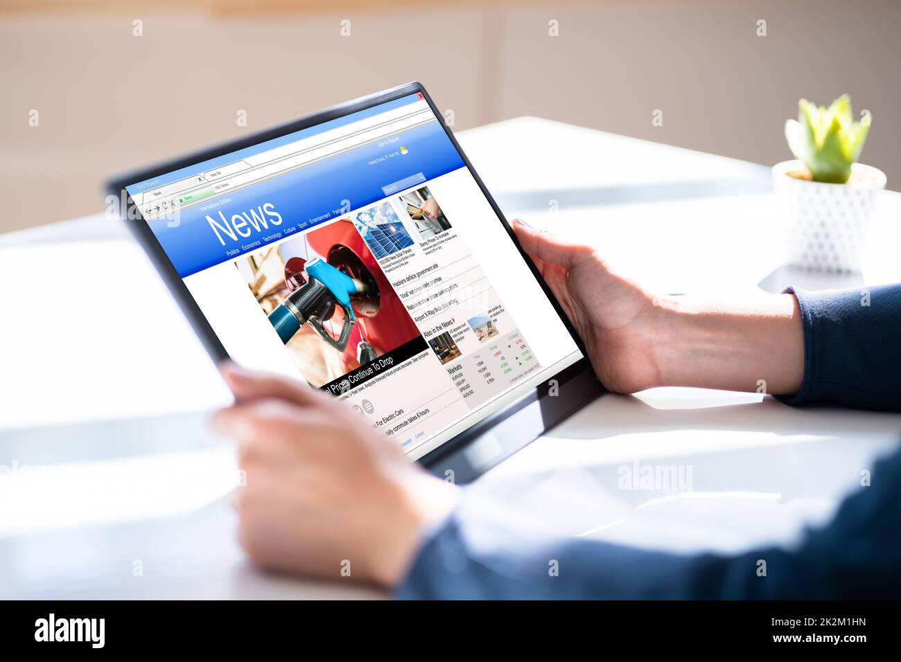 Woman reading newspaper on computer hi-res stock photography and images ...