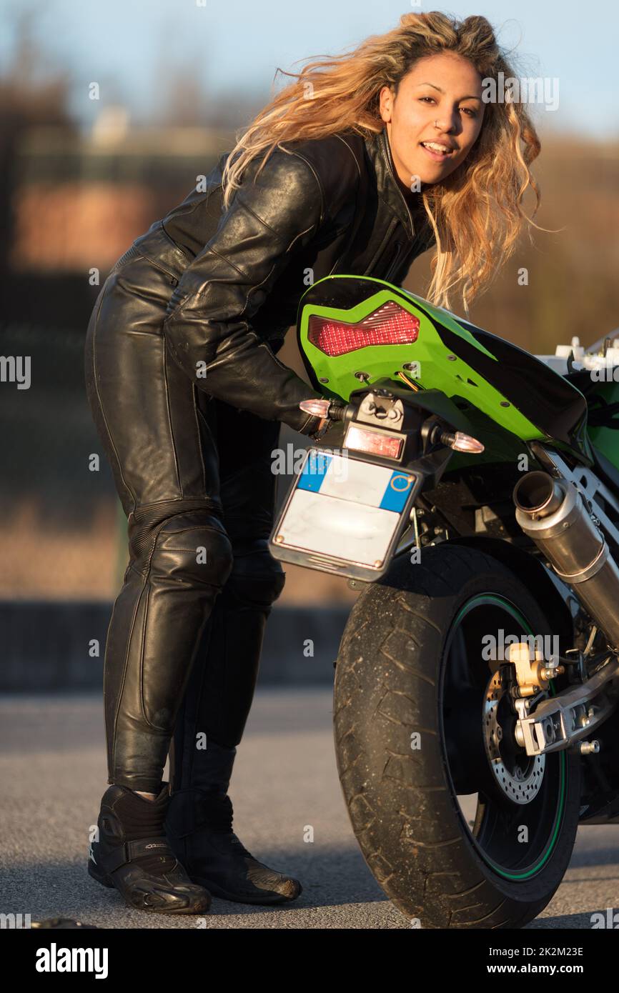 woman setting up her motorcycle to run Stock Photo - Alamy