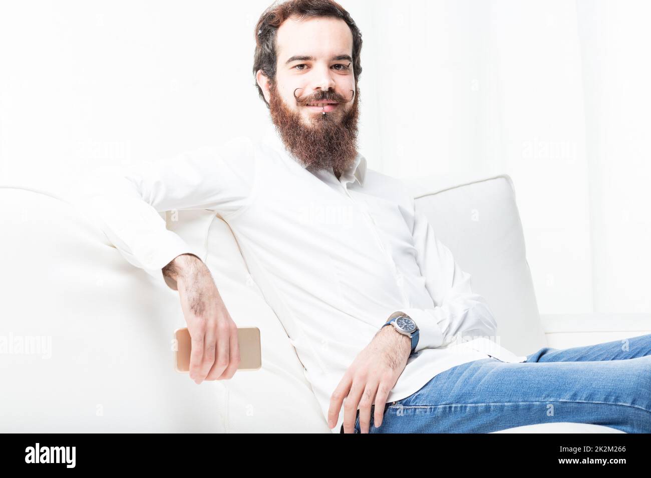 young modern man on his couch Stock Photo - Alamy