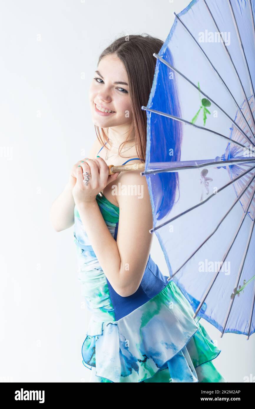 beautiful girl nicely smiling with a blue Eastern parasol Stock Photo ...