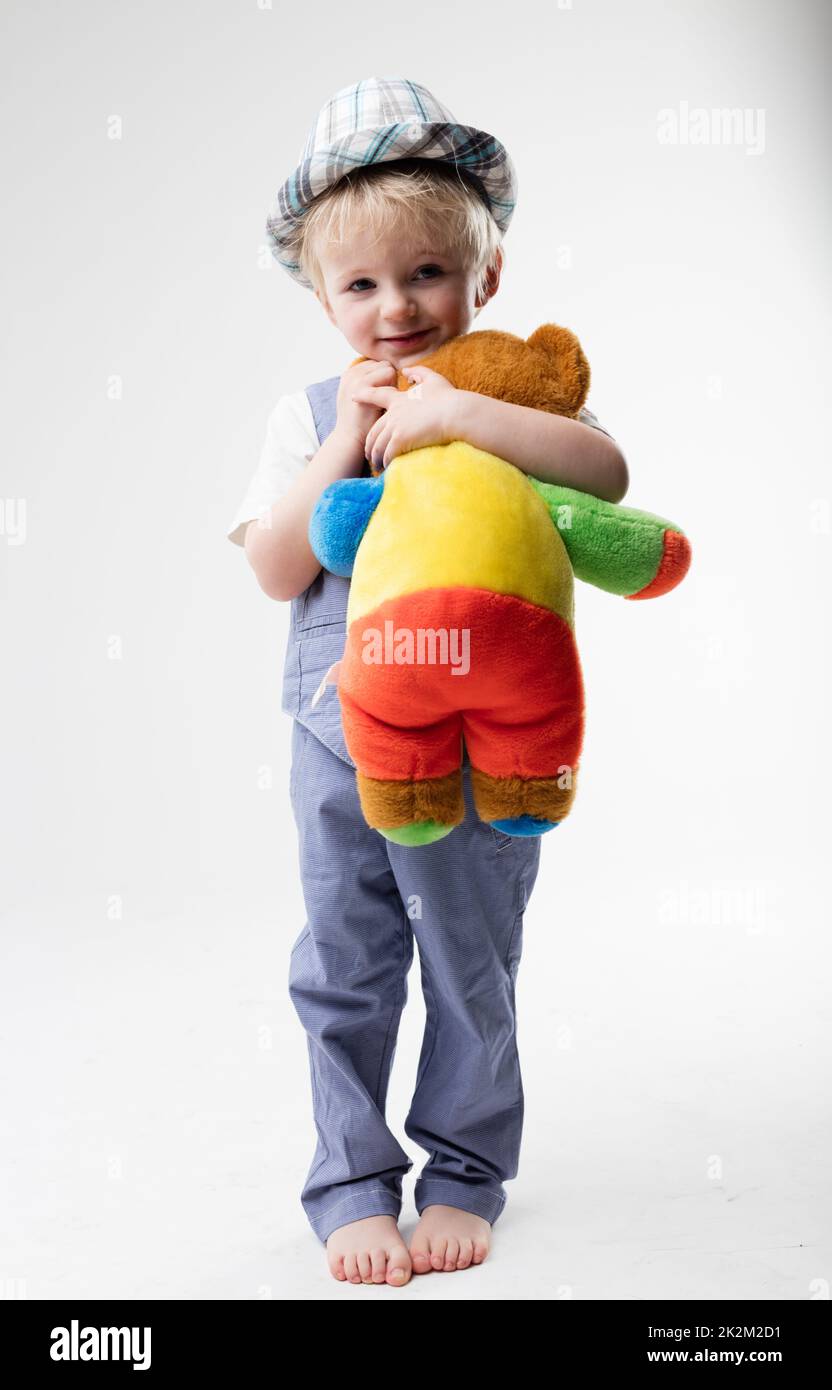little baby with hat hugging his teddy bear Stock Photo - Alamy