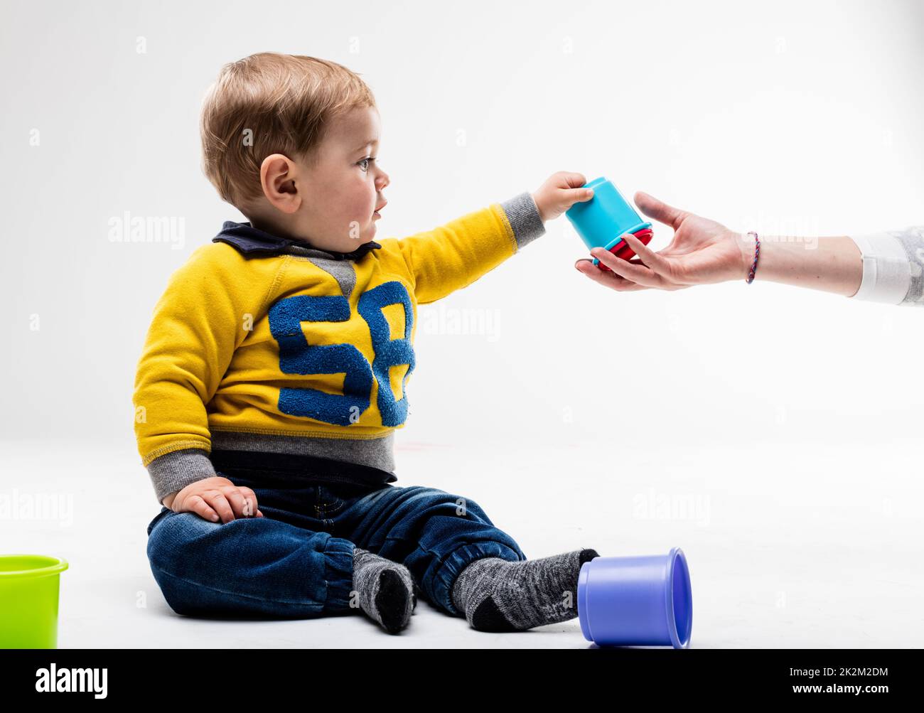 adult hand passes the baton to the baby hand Stock Photo - Alamy