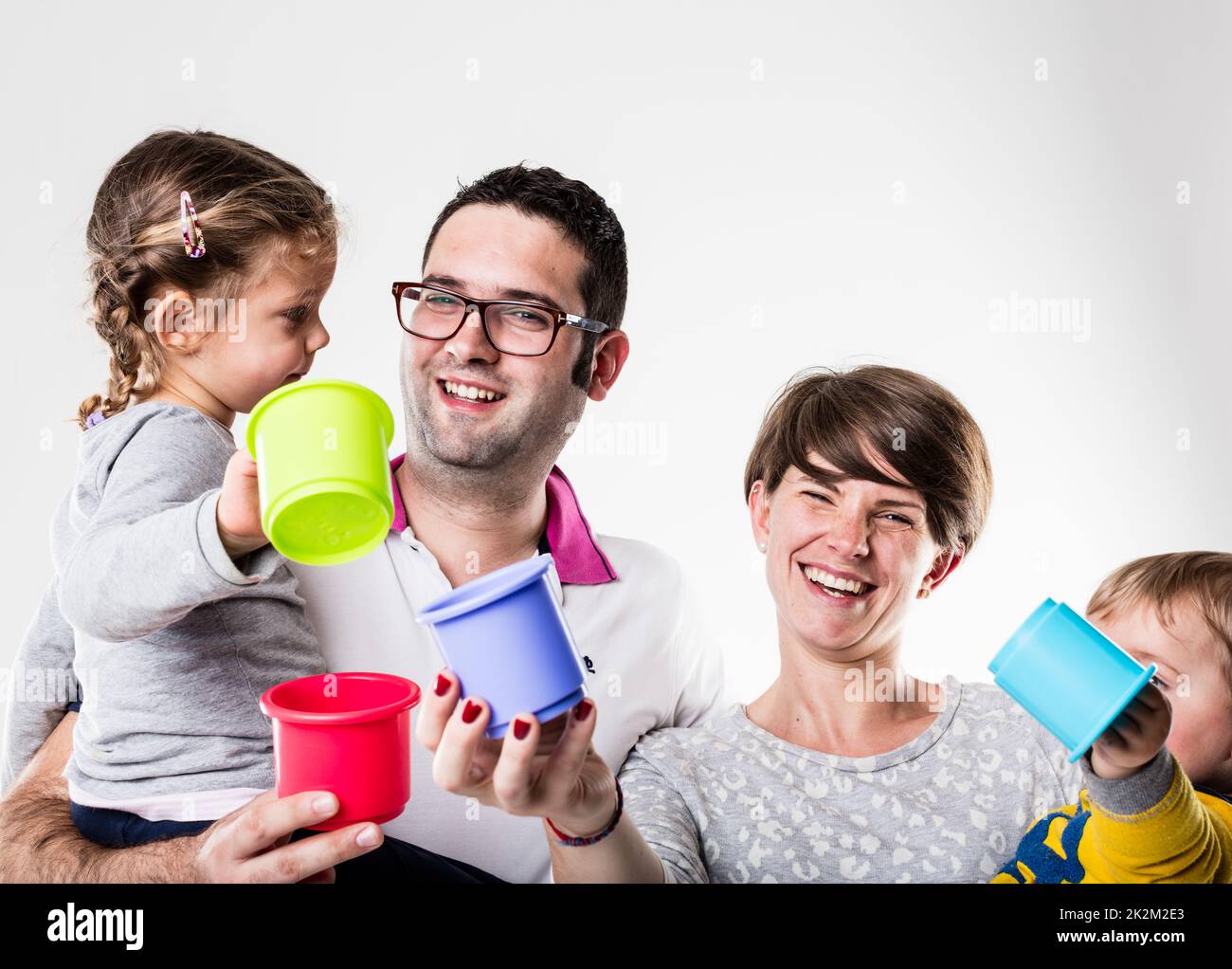 happy family laughing with colorful toys Stock Photo - Alamy