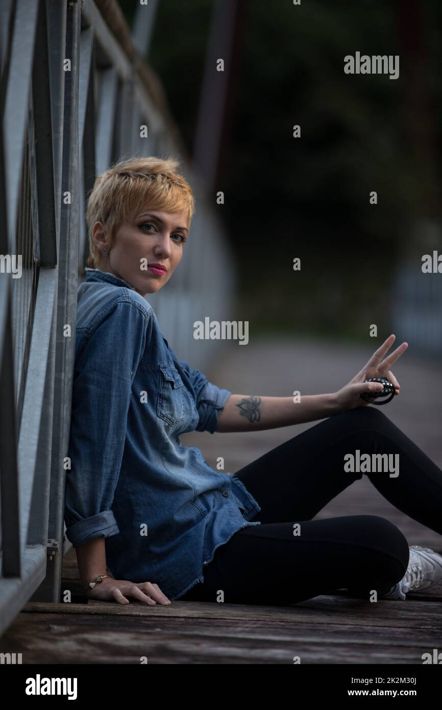 Modern trendy young woman making a V-sign Stock Photo - Alamy