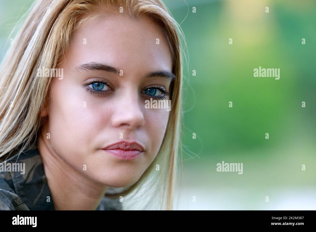 Outdoor Portrait Of Young Blonde Woman With Intense Gaze Natural