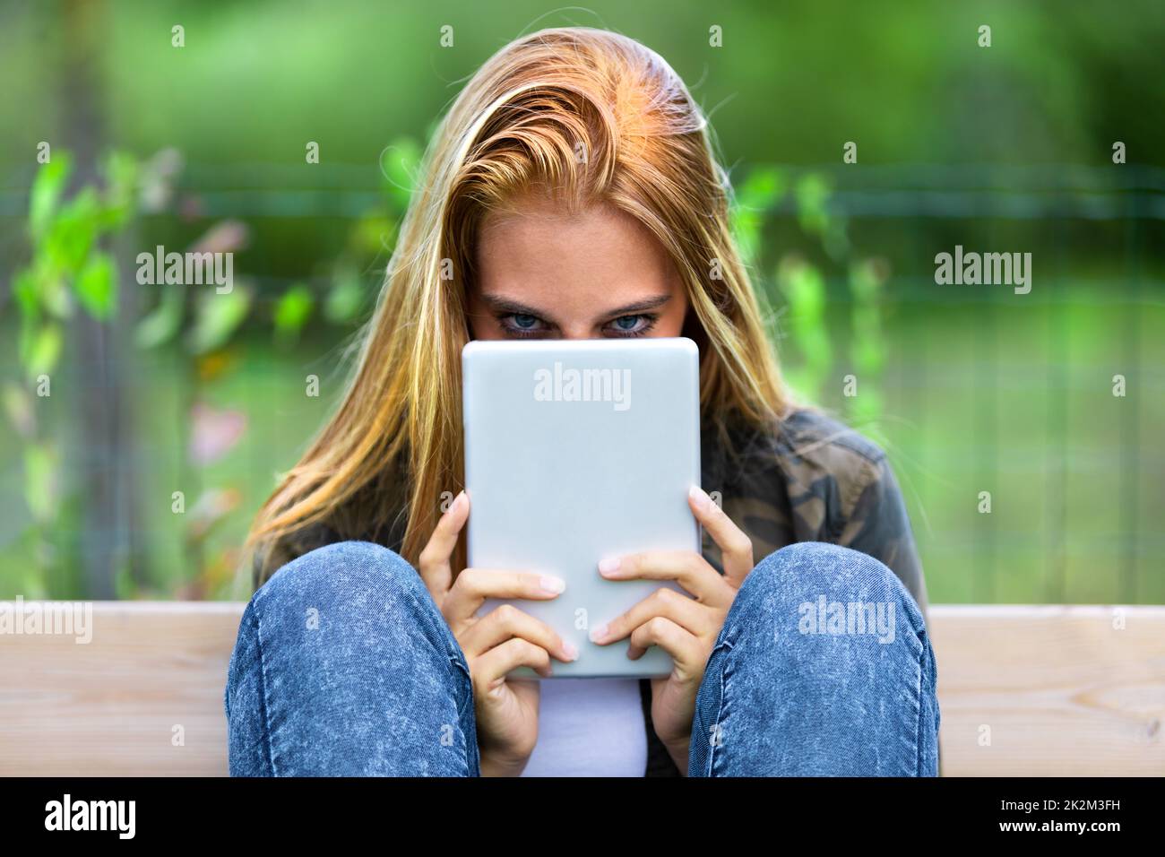 Woman peering over computer hi-res stock photography and images - Alamy