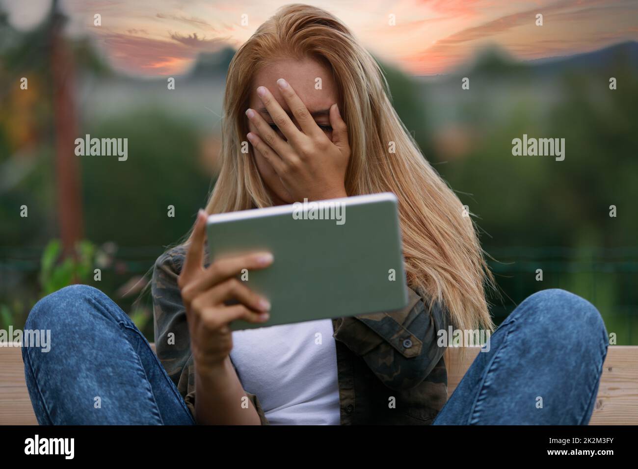 Embarrassed or bashful young woman covering her face Stock Photo - Alamy