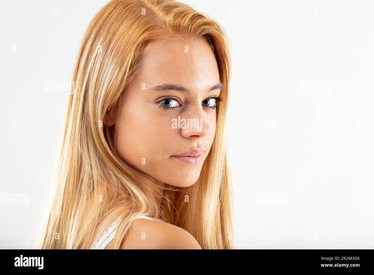 Attractive young woman turning to camera Stock Photo - Alamy