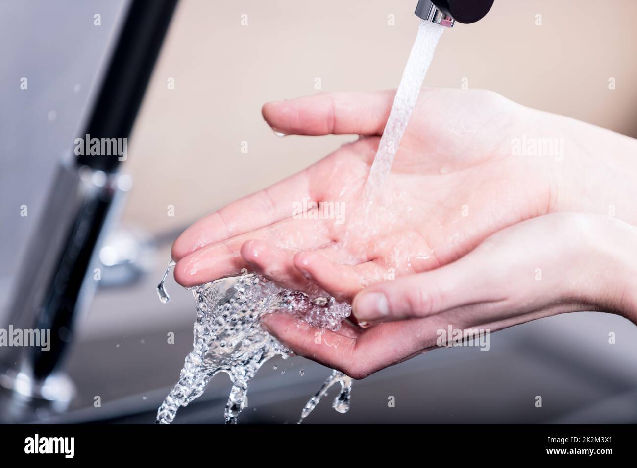 Woman washing her hands under running water Stock Photo - Alamy