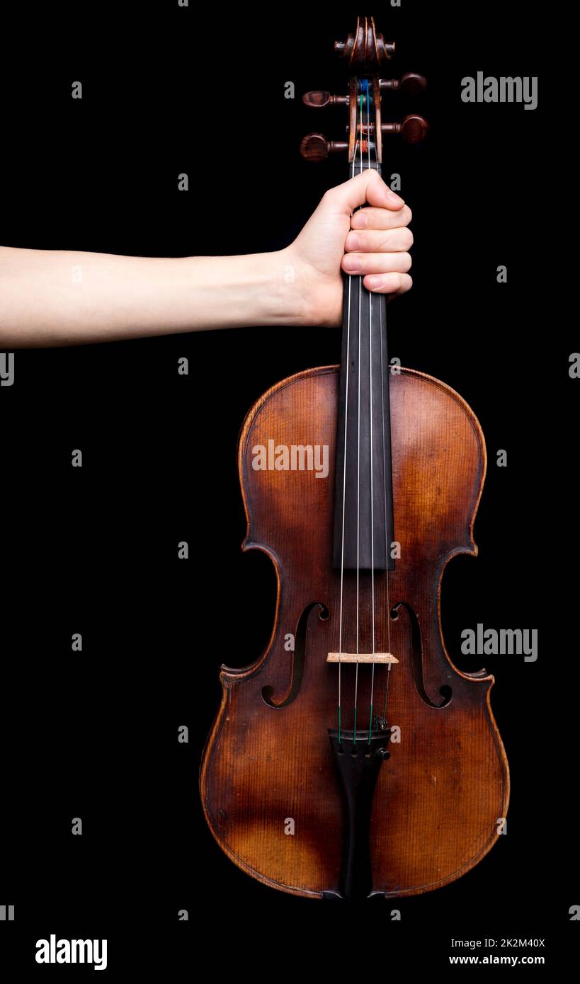 hand holding a violin on black Stock Photo - Alamy