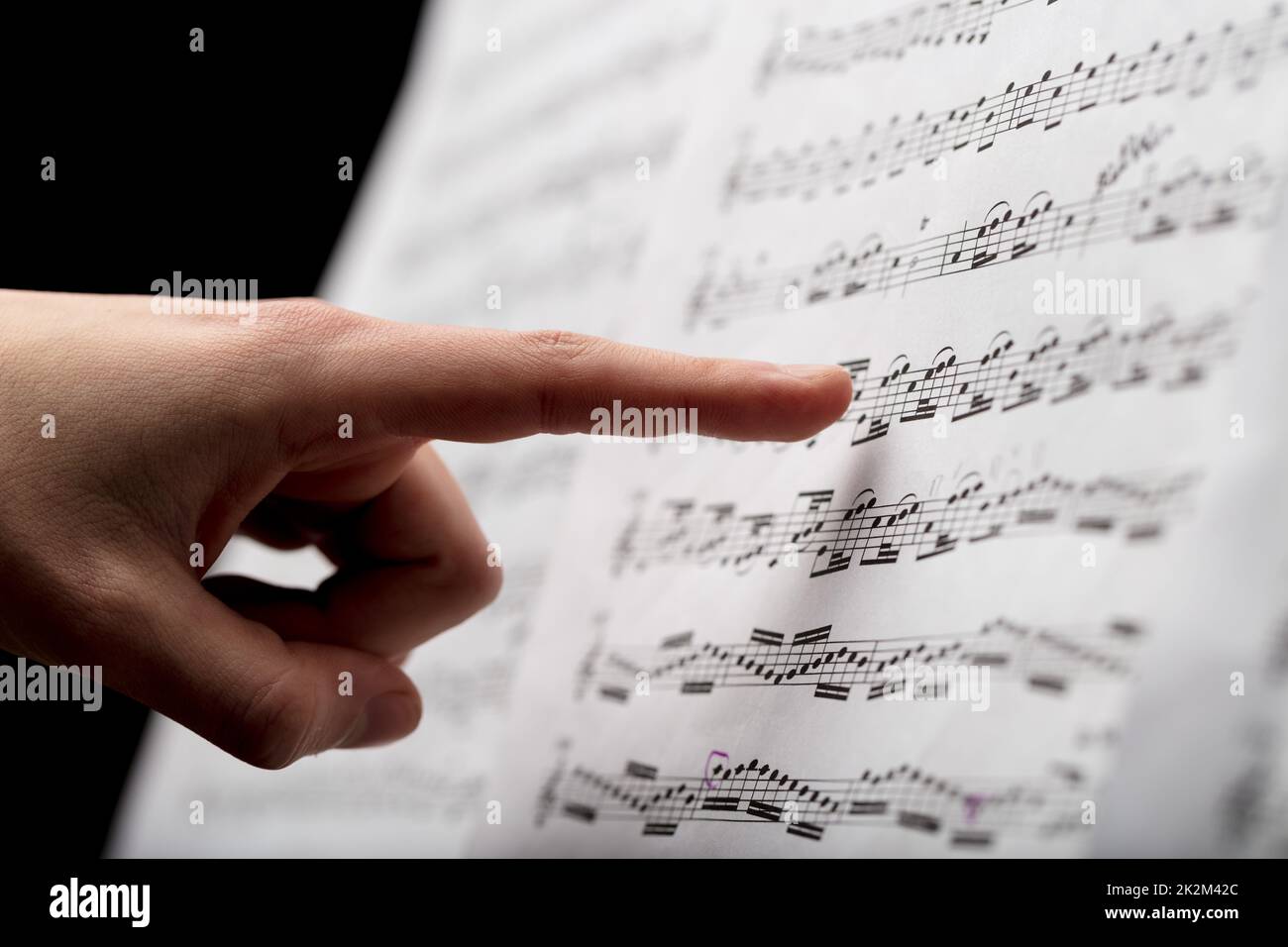 finger pointing to music score Stock Photo - Alamy