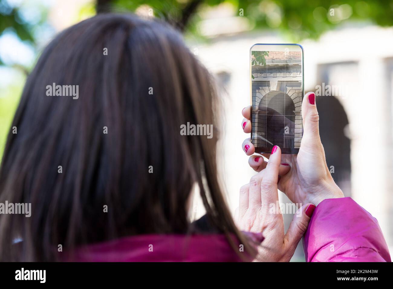 woman in a city taking photographs with transparent phone Stock Photo ...