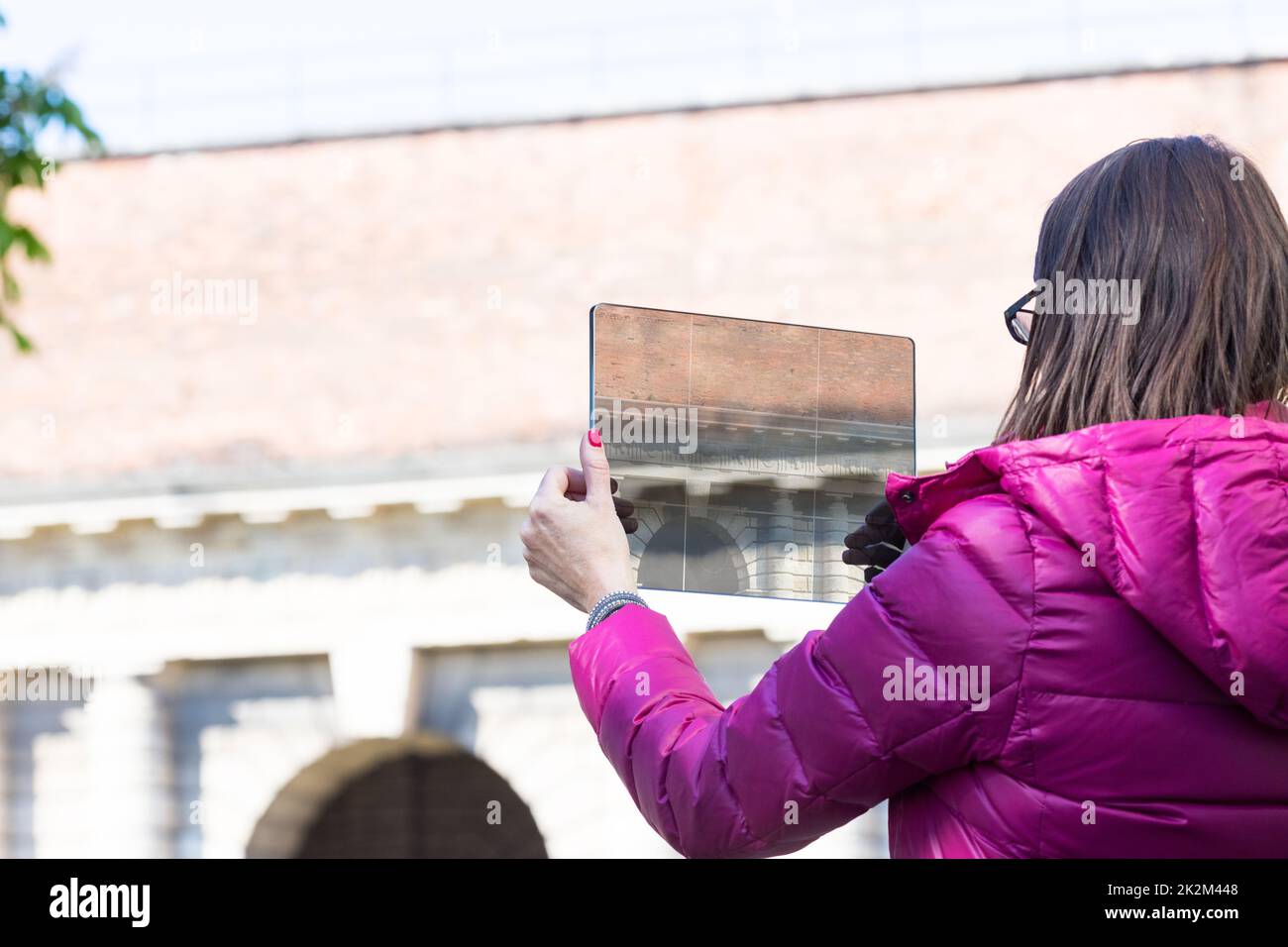 woman in a city taking photographs with transparent tablet Stock Photo ...