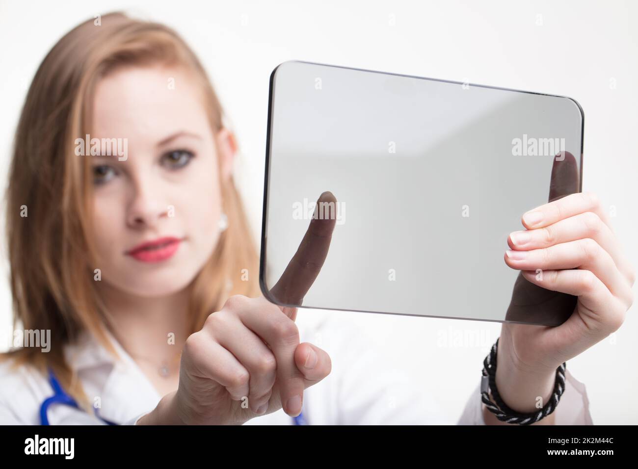 Pretty doctor or nurse using a transparent tablet Stock Photo - Alamy