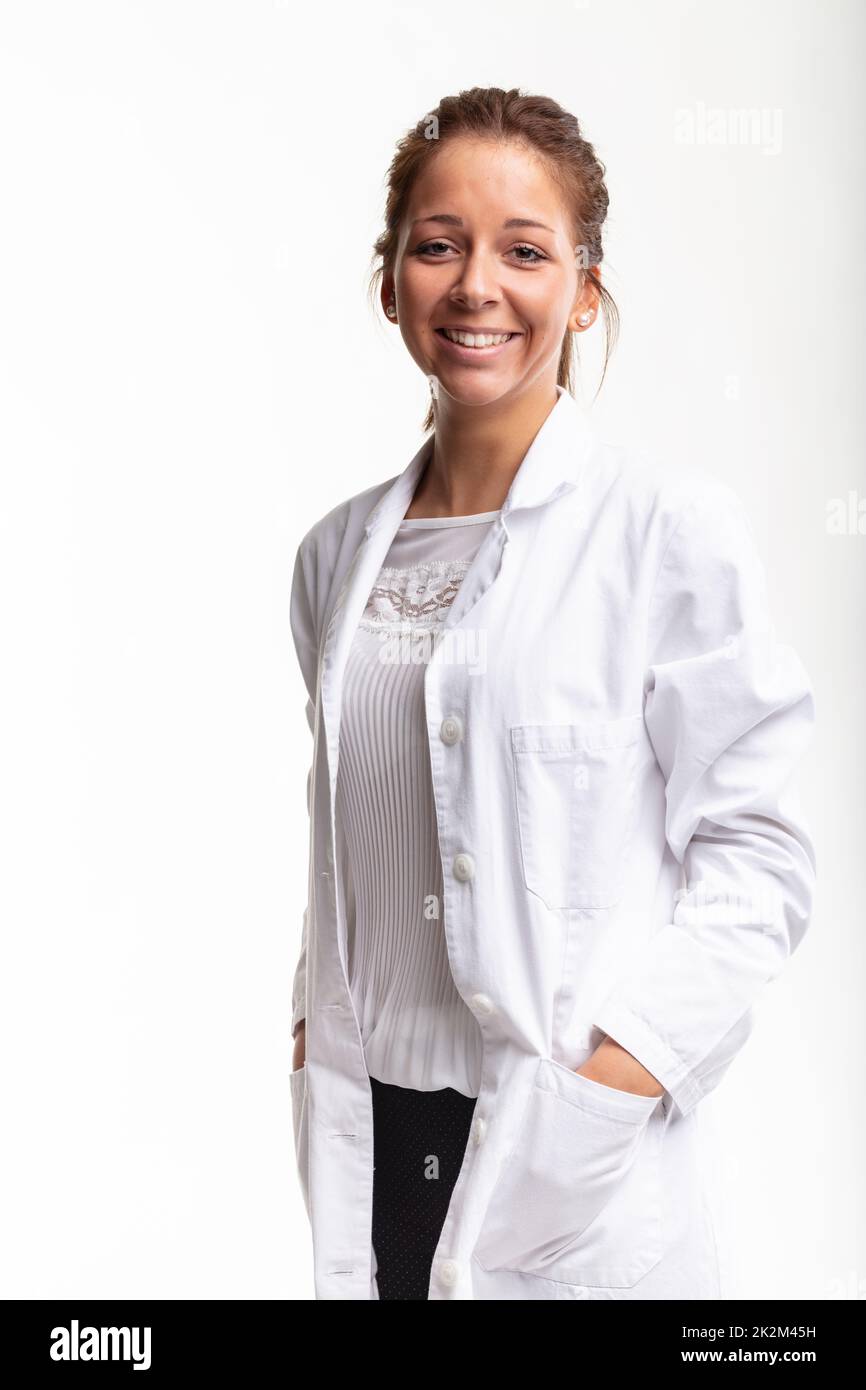 Smiling confident relaxed young woman in a white lab coat Stock Photo ...