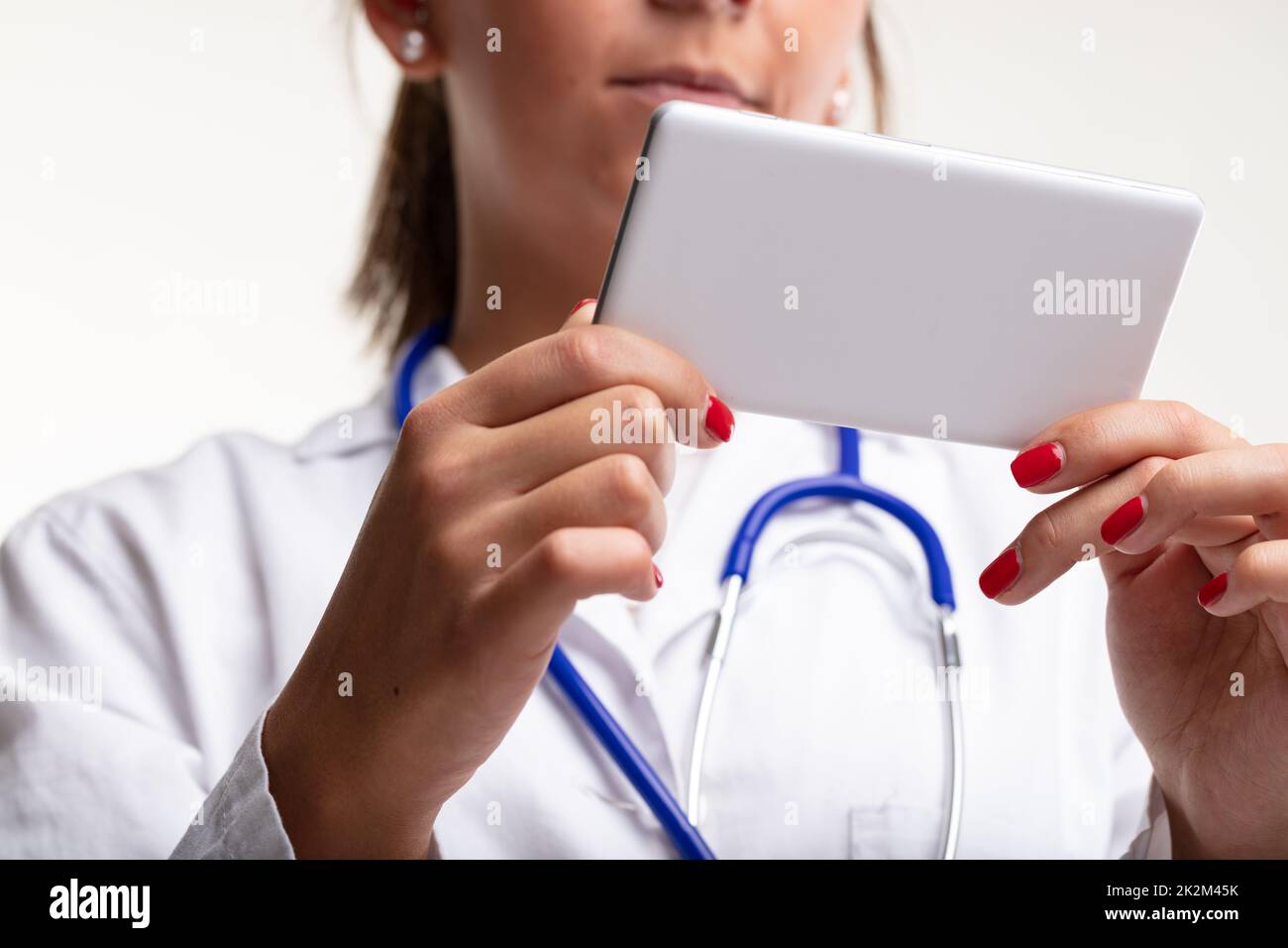Female doctor or nurse reading a message on her mobile phone Stock ...