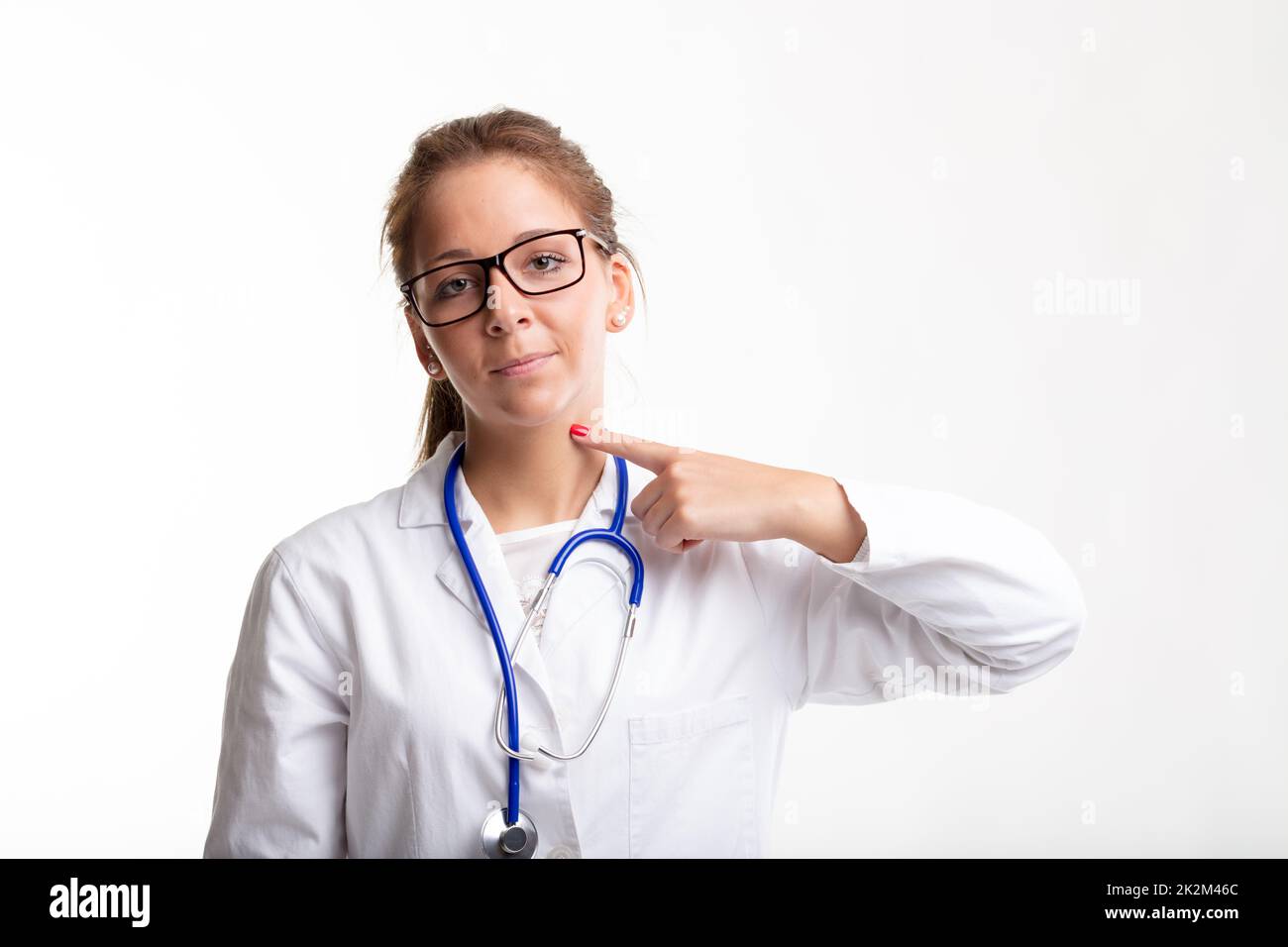 Female doctor or nurse pointing to her neck Stock Photo - Alamy